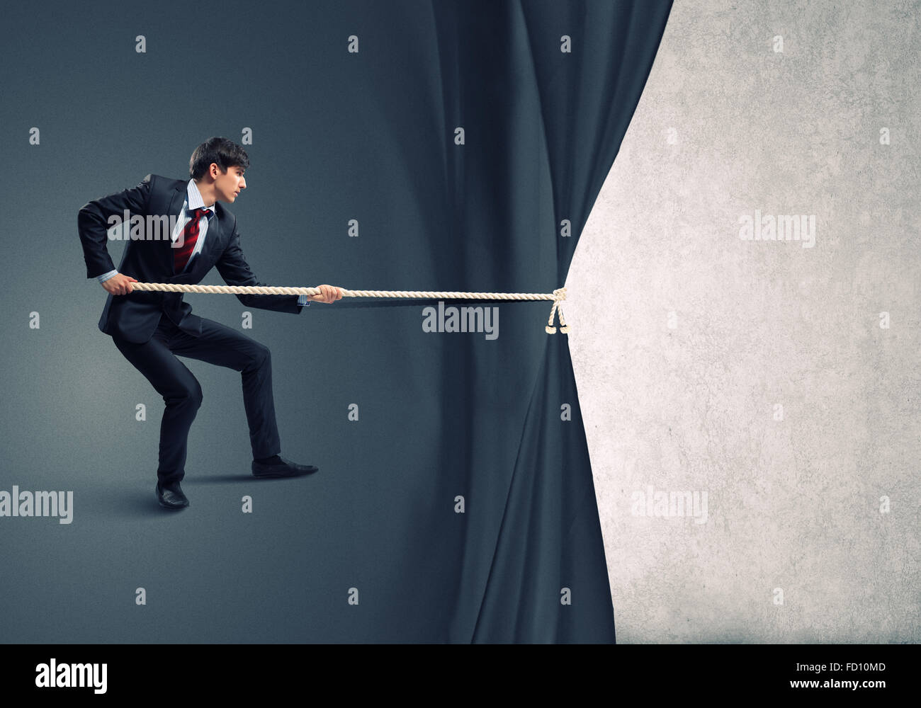 Young businessman pulling curtain with rope. Place for text Stock Photo ...
