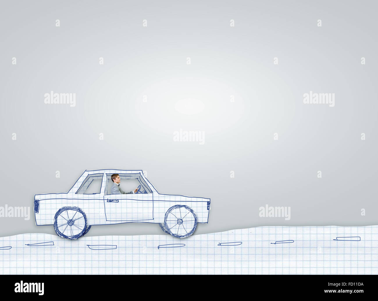 Young man driving car made of sheet of paper Stock Photo - Alamy