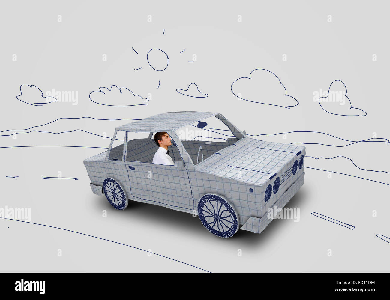 Young man driving car made of sheet of paper Stock Photo - Alamy