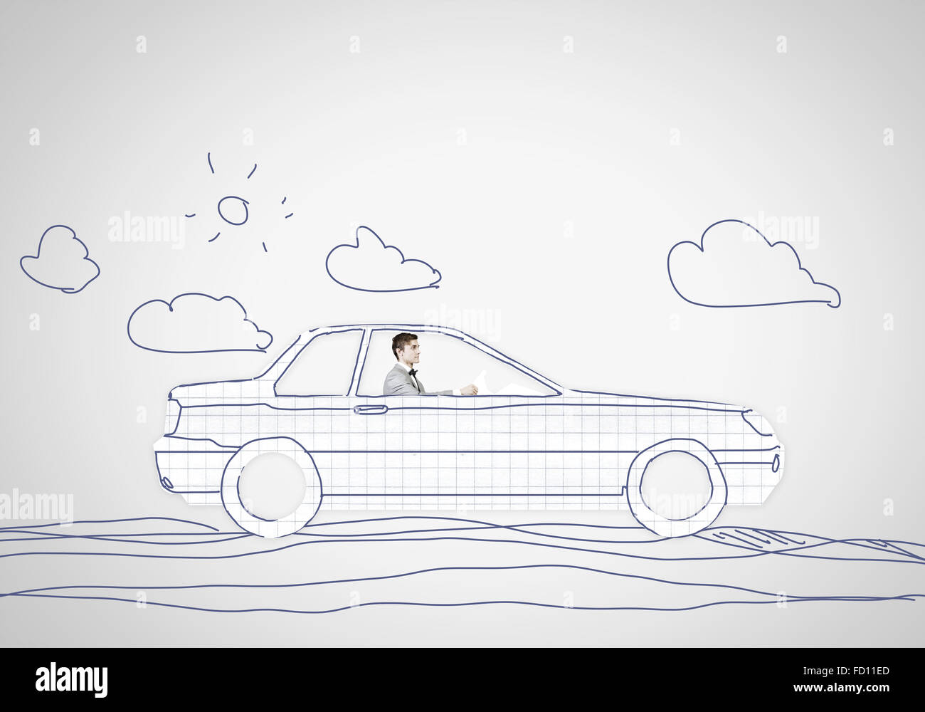 Young man driving car made of sheet of paper Stock Photo - Alamy