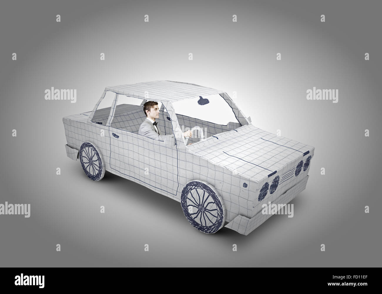 Young man driving car made of sheet of paper Stock Photo - Alamy
