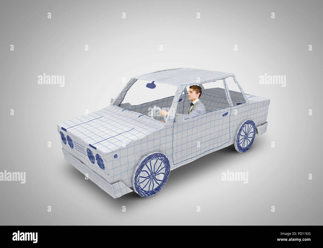 Young man driving car made of sheet of paper Stock Photo - Alamy