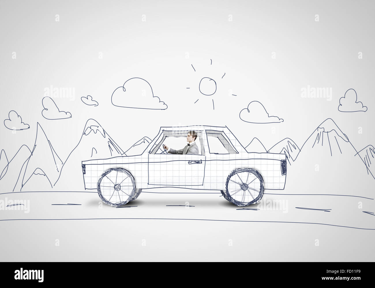 Young man driving car made of sheet of paper Stock Photo - Alamy