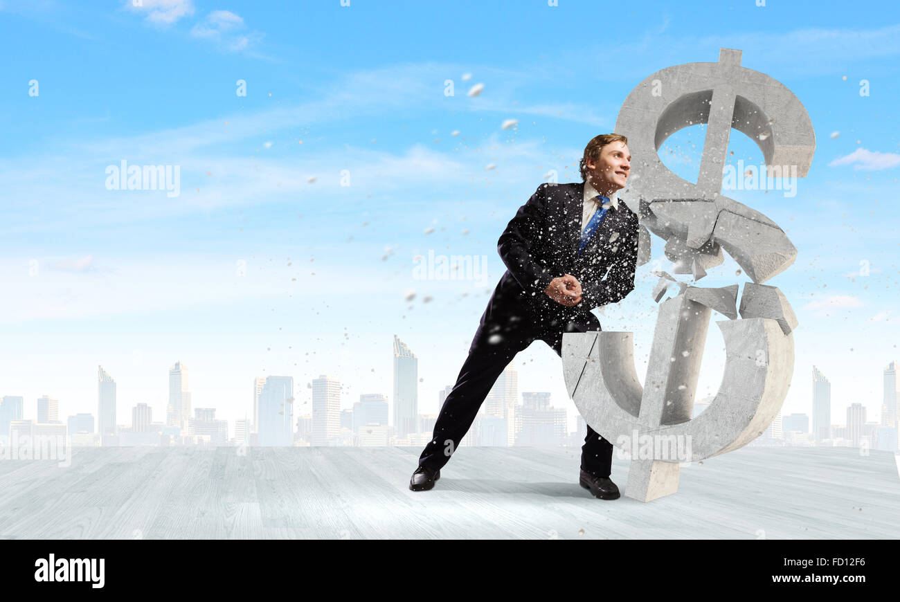 Young businessman breaking stone dollar sign. Currency concept Stock ...