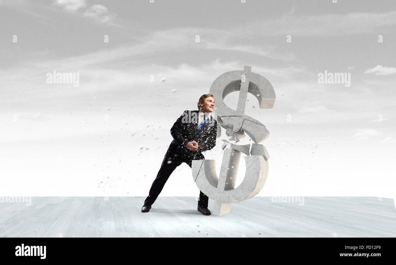 Young businessman breaking stone dollar sign. Currency concept Stock ...