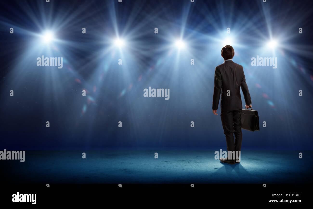 Rear view of businessman standing in lights of stage Stock Photo - Alamy