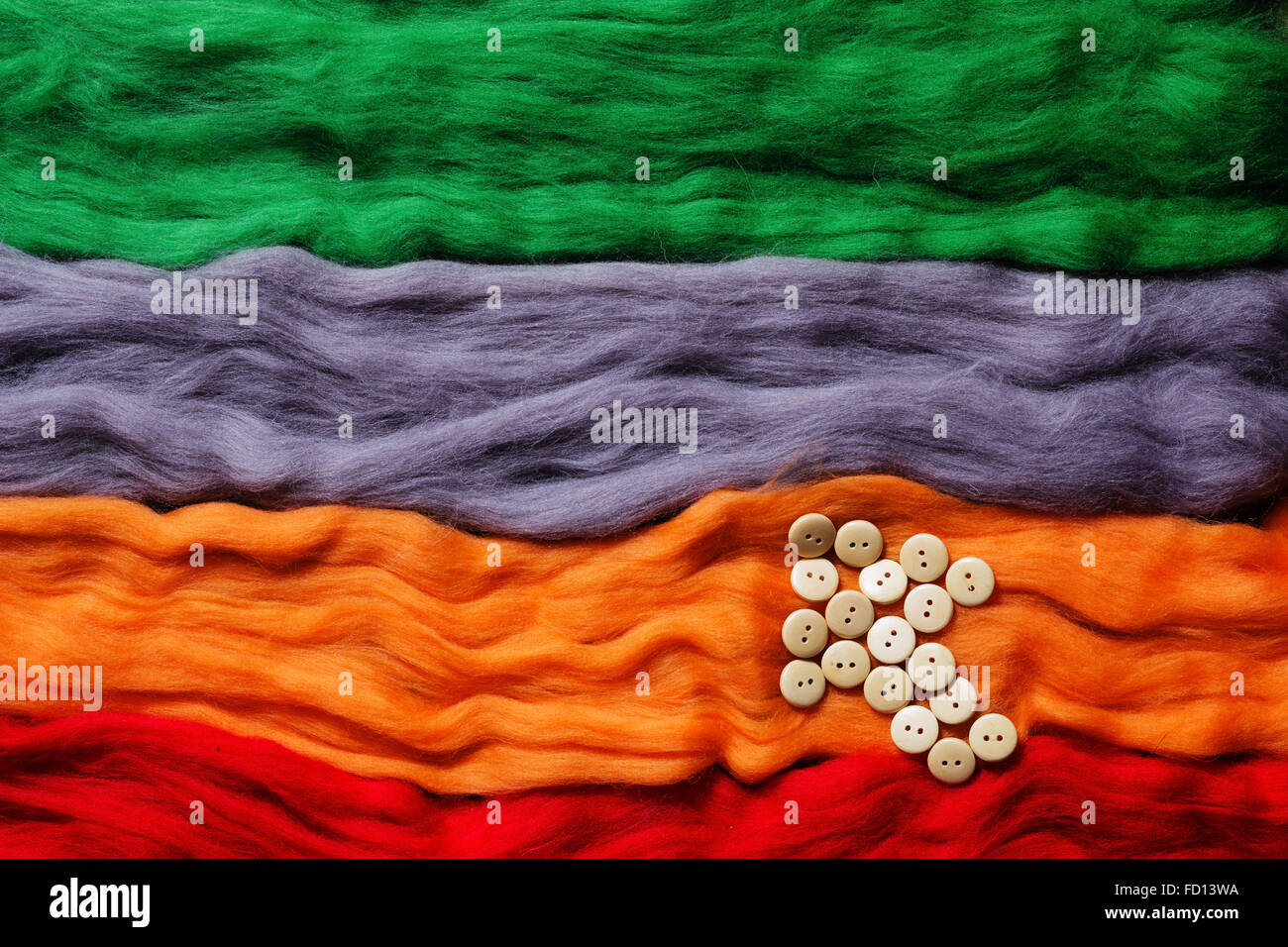 Multi-colored strands of wool felting and arrow made from buttons Stock ...