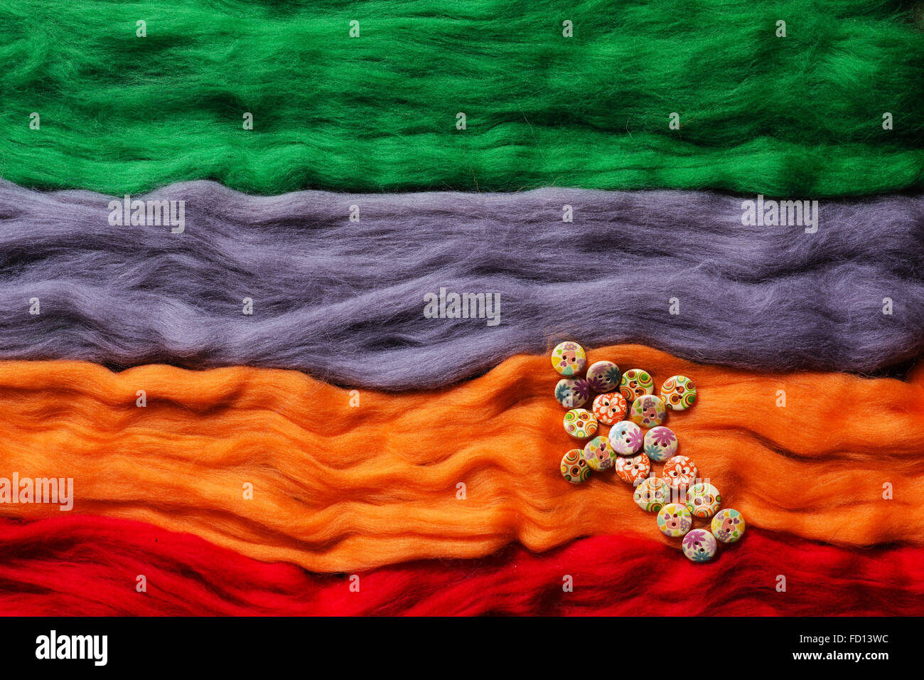 Multi-colored strands of wool felting and arrow made from buttons Stock ...