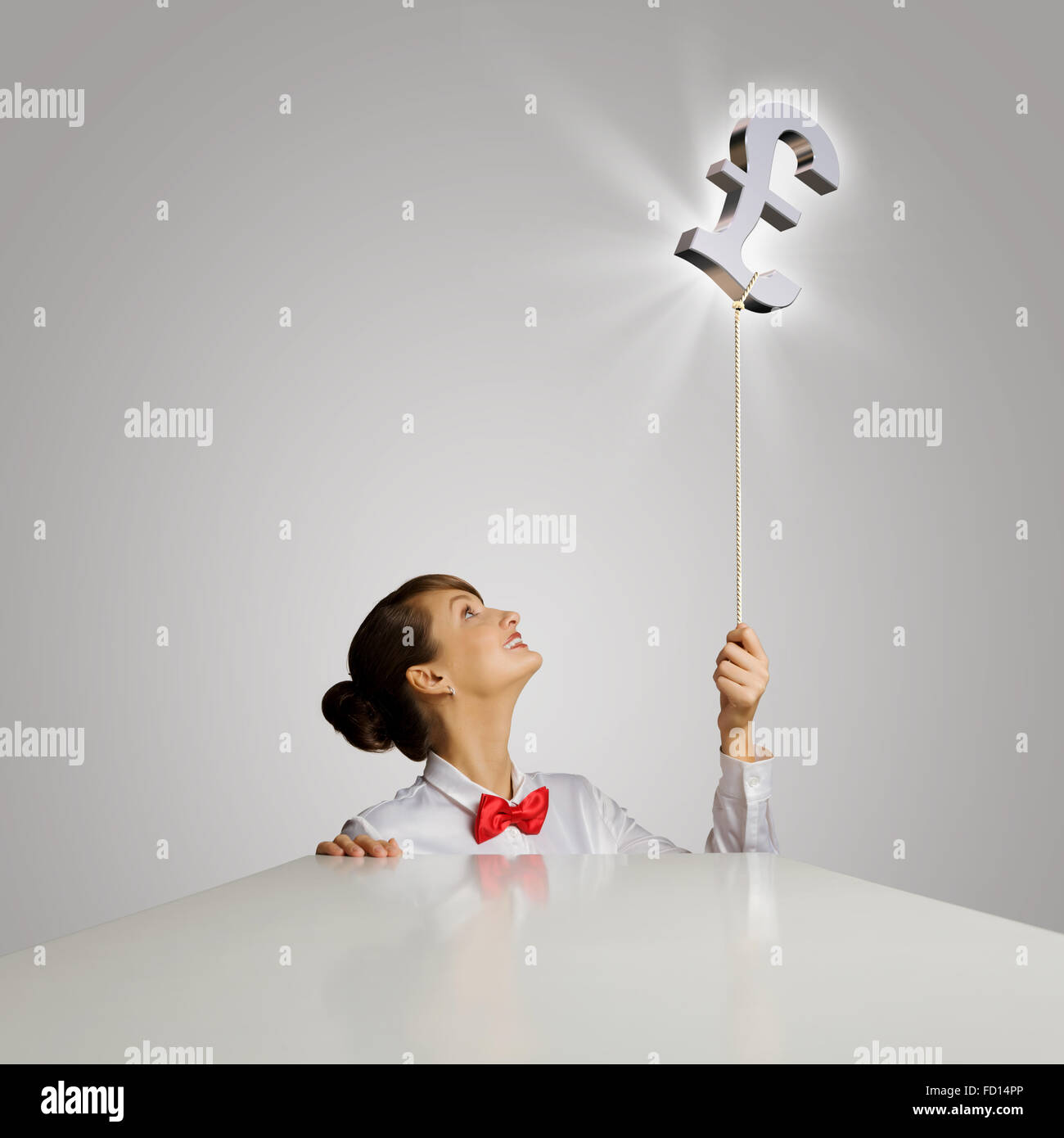 Young woman holding balloon shaped like pound sign Stock Photo - Alamy