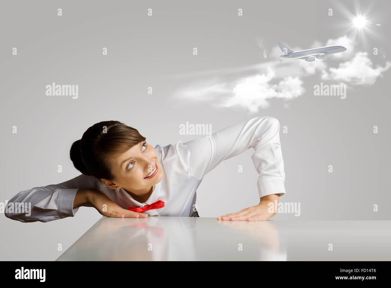 Young woman leaning above table and looking at airplane in sky Stock ...