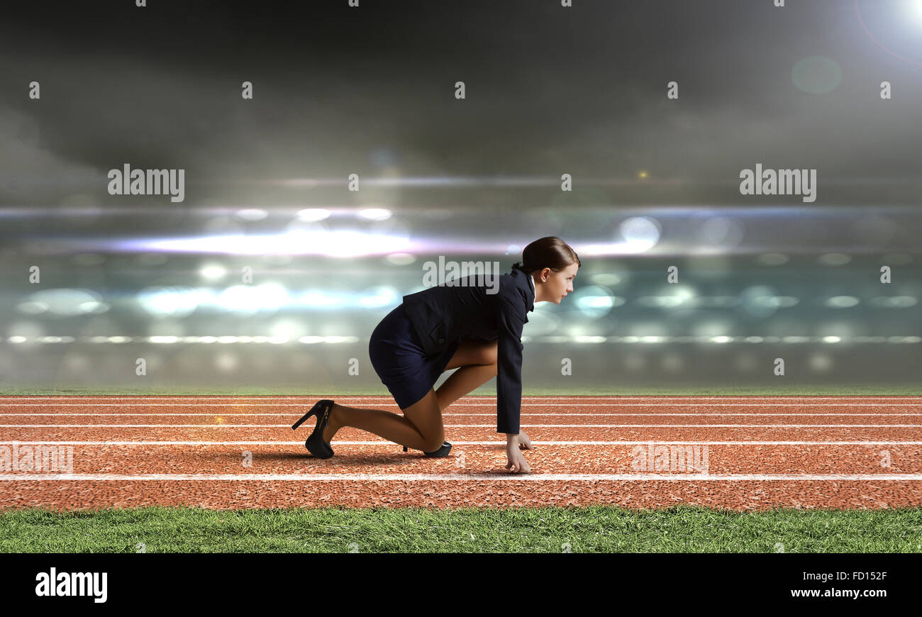 Side view of businesswoman at stadium standing in start position Stock ...