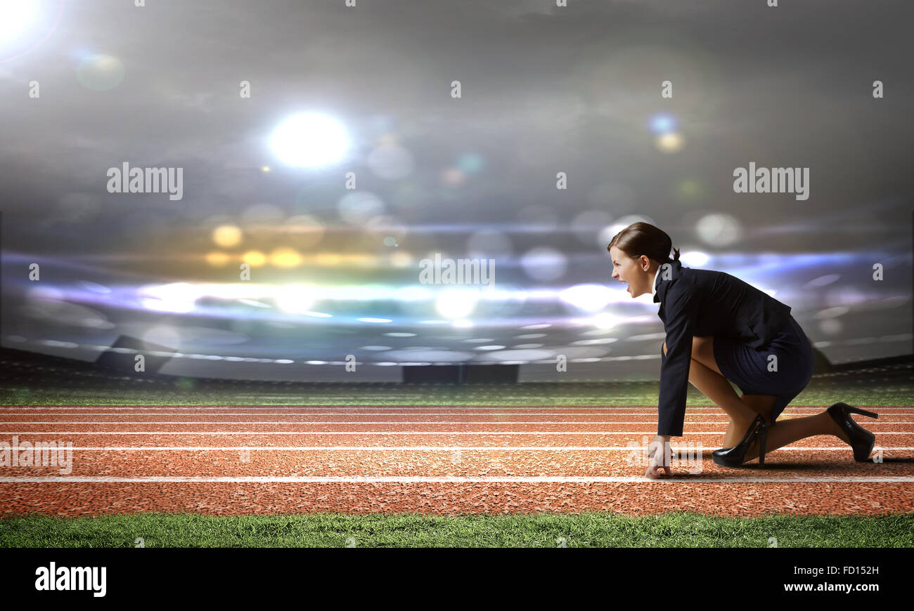 Side view of businesswoman at stadium standing in start position Stock ...