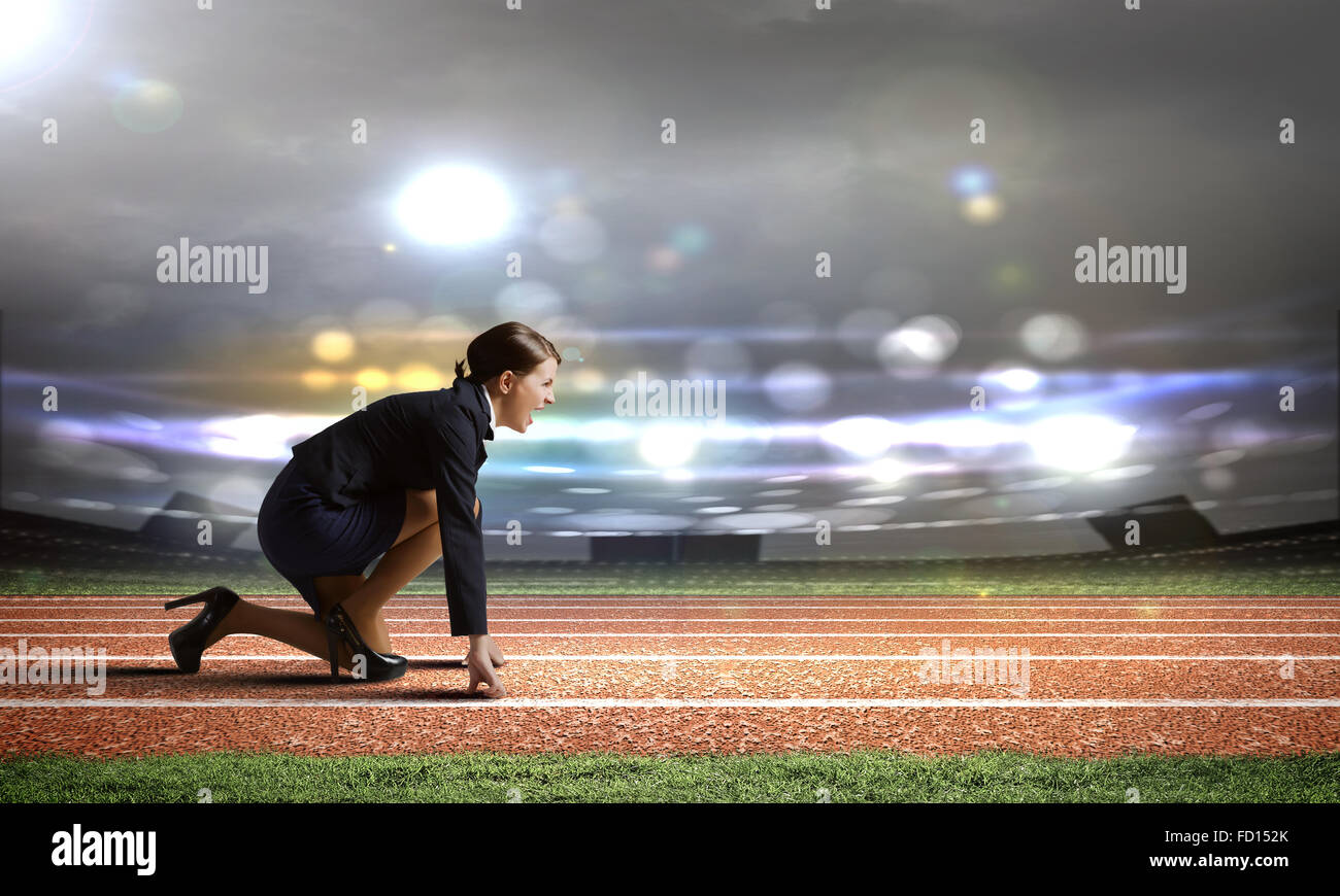 Side view of businesswoman at stadium standing in start position Stock ...