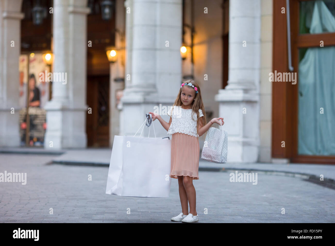 Adorable little girl walking with shopping bags in Paris outdoors Stock ...