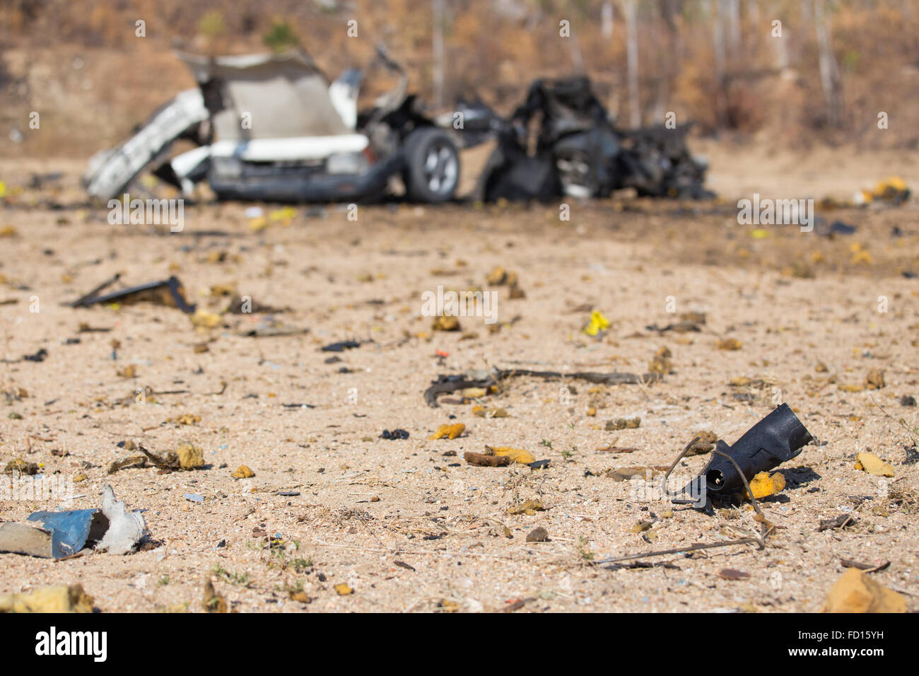 wrecked car and evidence pieces scatter on ground from explosion ...
