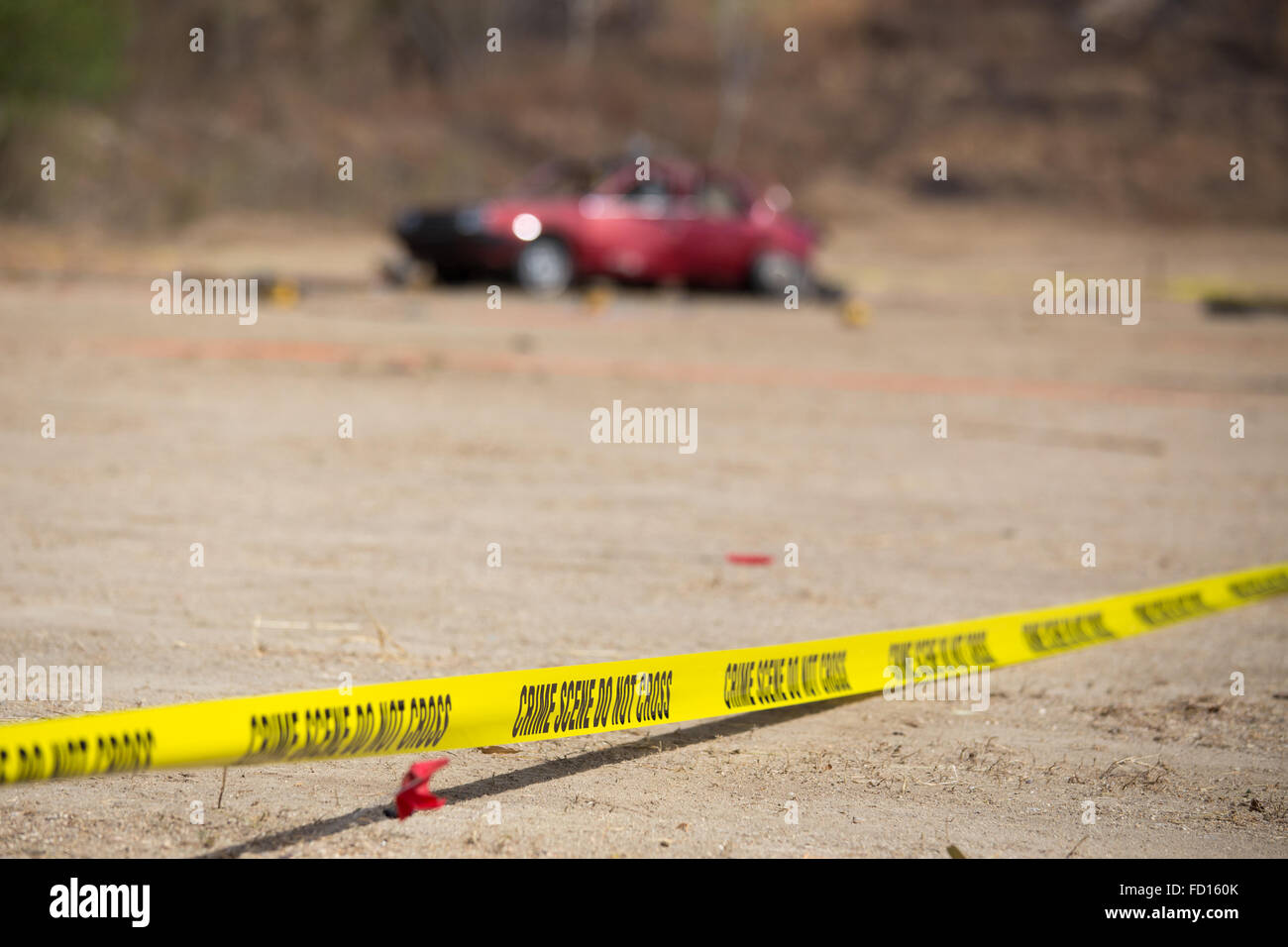 crime scene do not cross tape with wrecked vehicle from explosion or ...