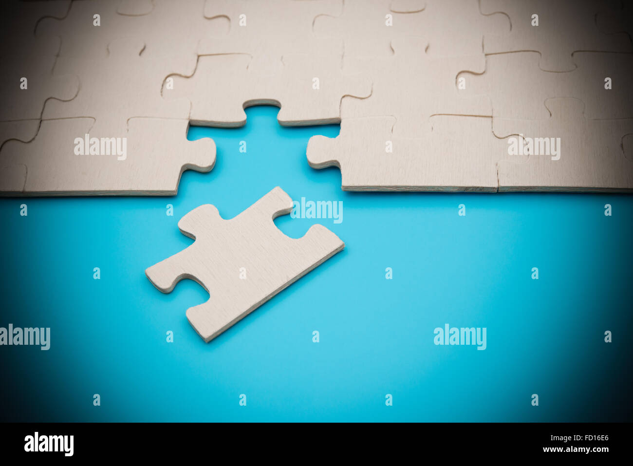 jigsaw puzzle with one piece separated on blue background Stock Photo ...