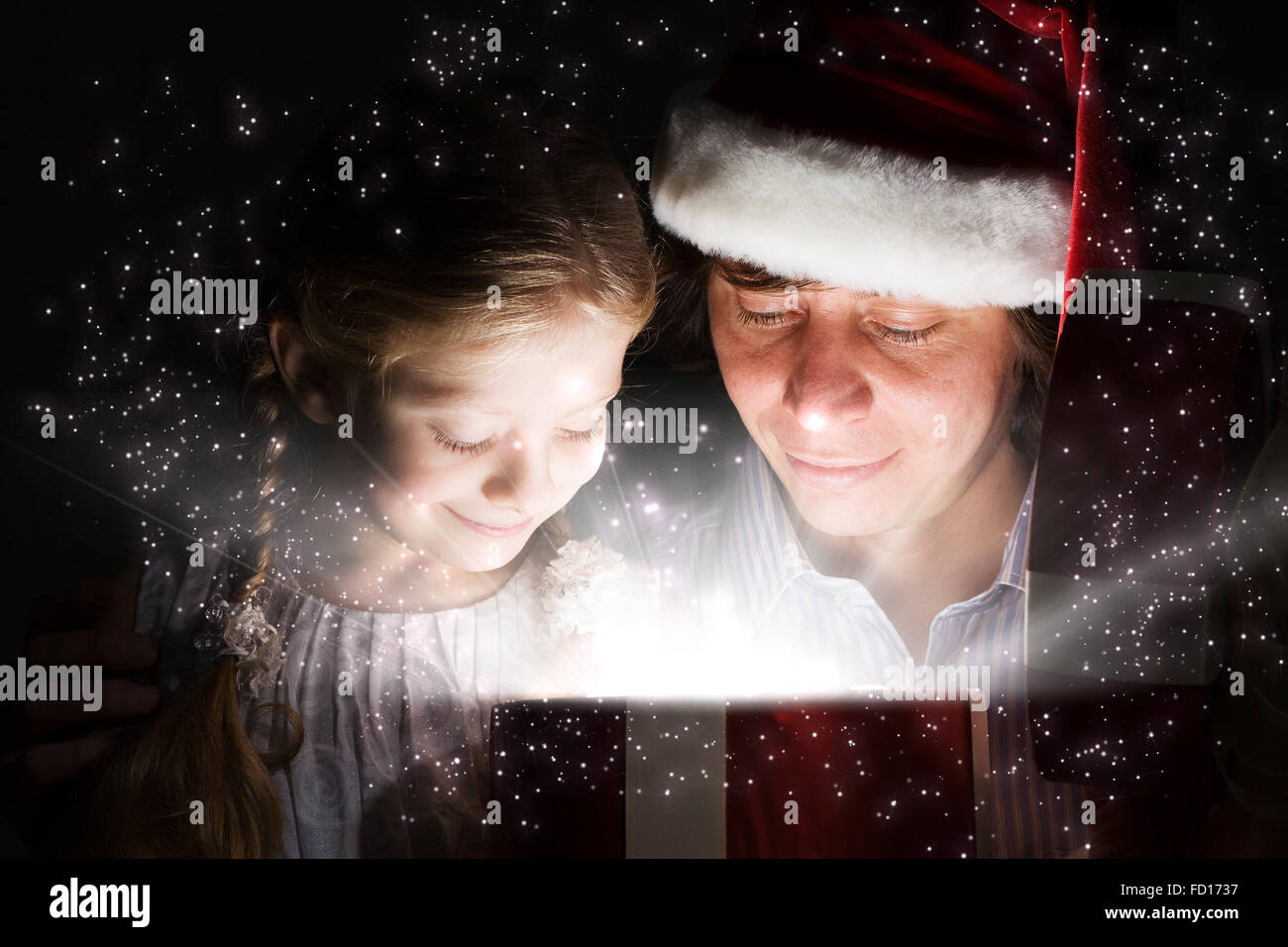 Happy daughter getting Christmas present from father Stock Photo - Alamy