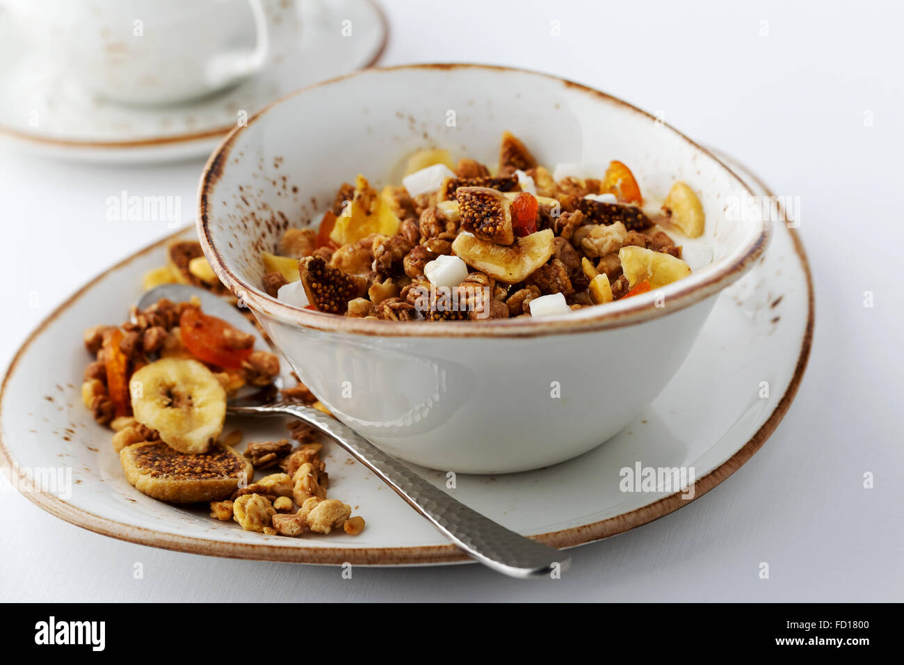 Authentic muesli and a cup of tea sprinkled with cinnamon on a white ...