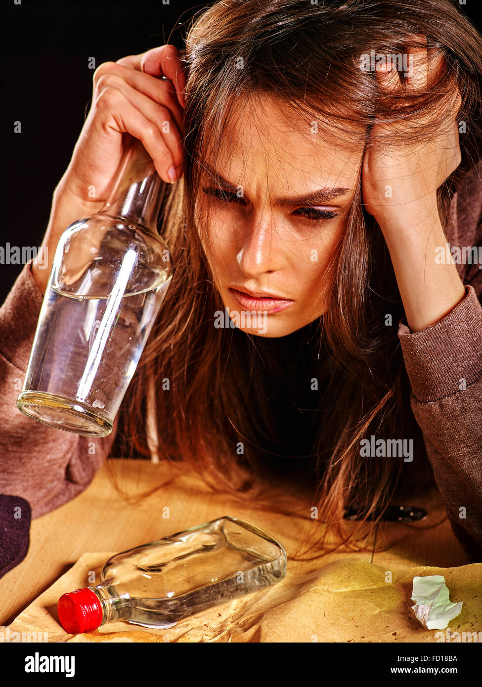 Drunk girl holding bottle of vodka Stock Photo - Alamy