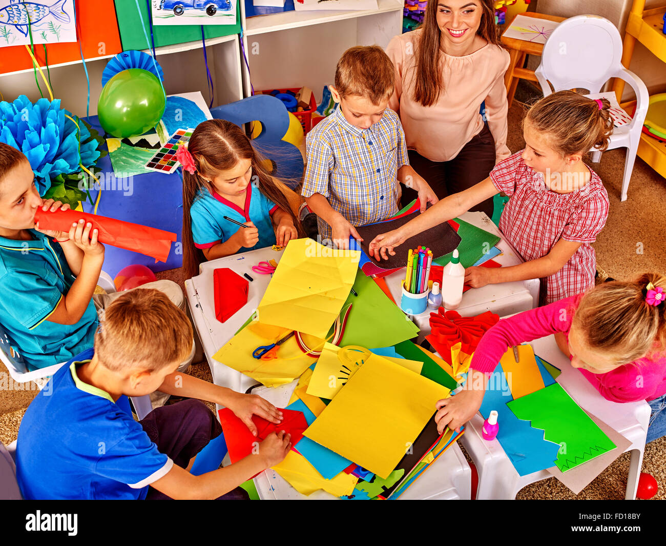 Female kid work with colored paper in beginner school Stock Photo - Alamy