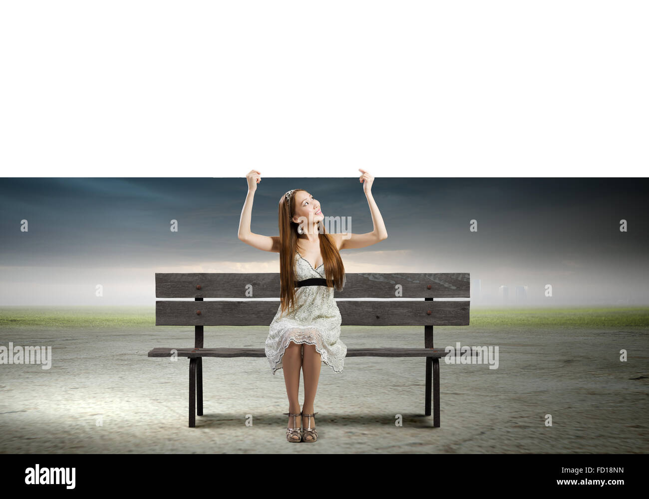 Young asian woman sitting on bench with blank banner Stock Photo - Alamy