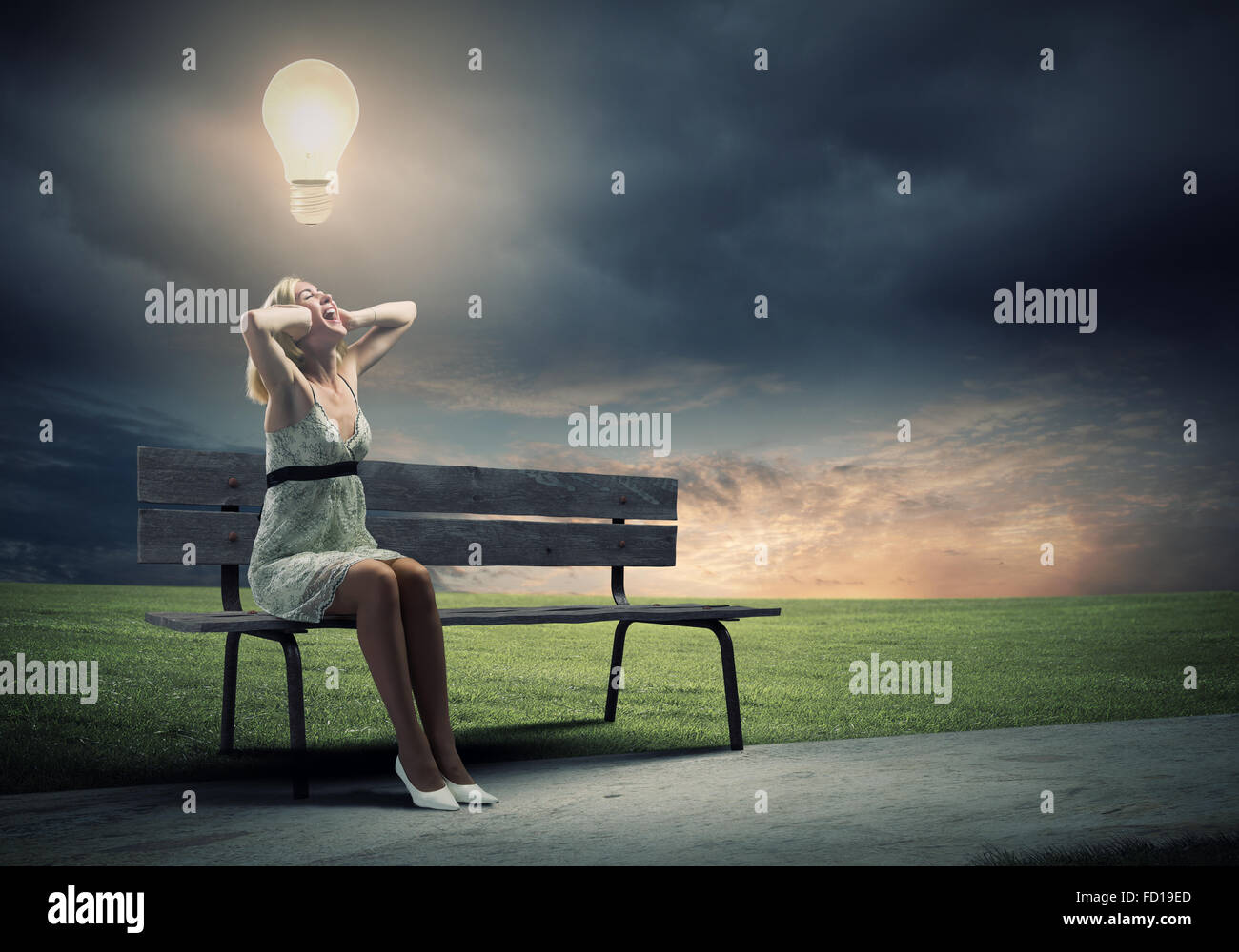Young woman sitting on bench closing ears with palms and screaming ...