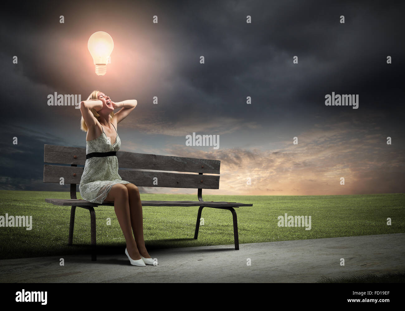 Young woman sitting on bench closing ears with palms and screaming ...