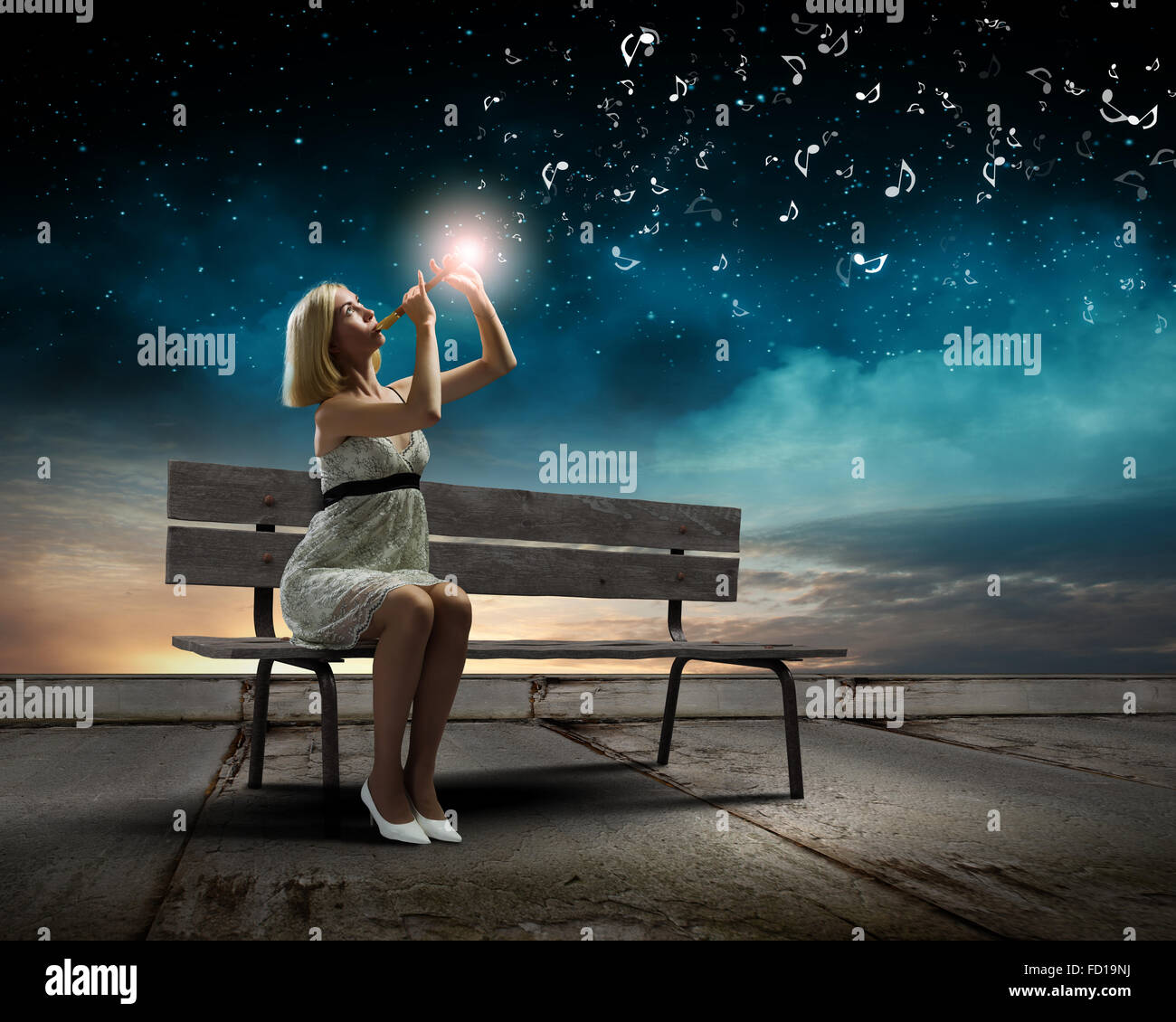 Young woman sitting on bench and playing fife Stock Photo - Alamy