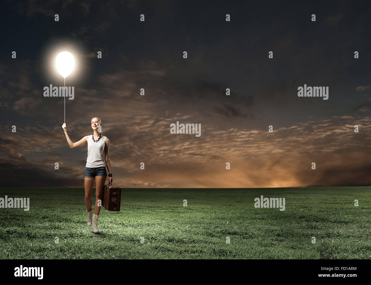Young woman hiker walking with suitcase in hand Stock Photo - Alamy