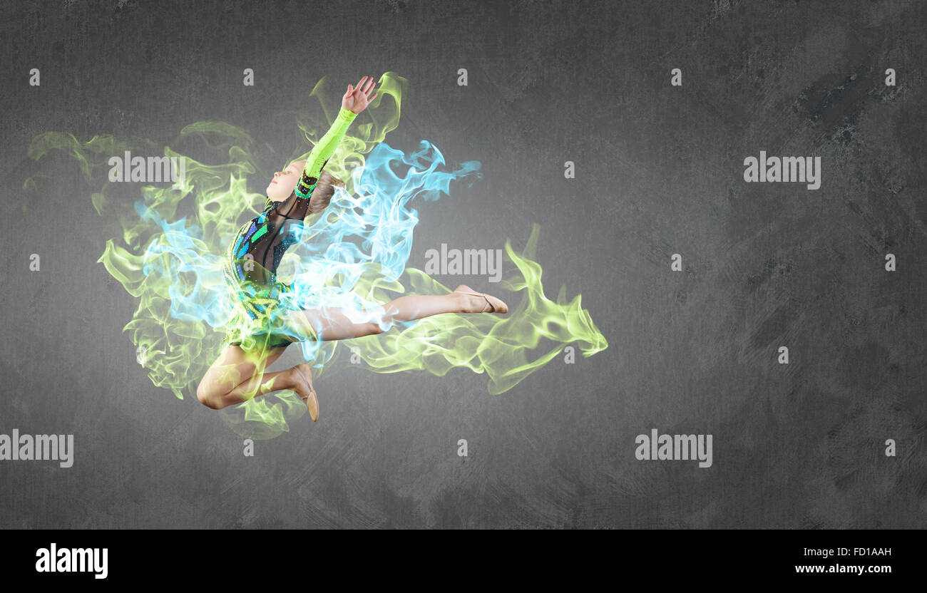 Little cute girl gymnast making high jump Stock Photo - Alamy