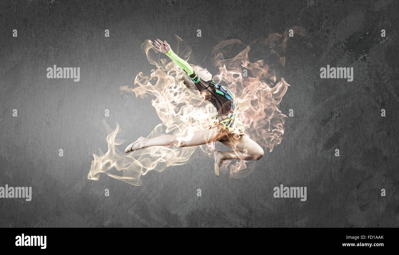 Little cute girl gymnast making high jump Stock Photo - Alamy