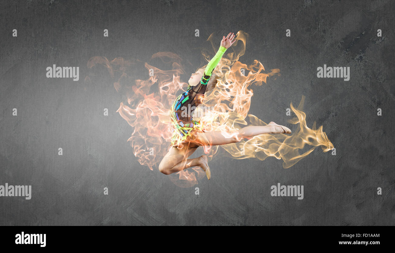 Little cute girl gymnast making high jump Stock Photo - Alamy