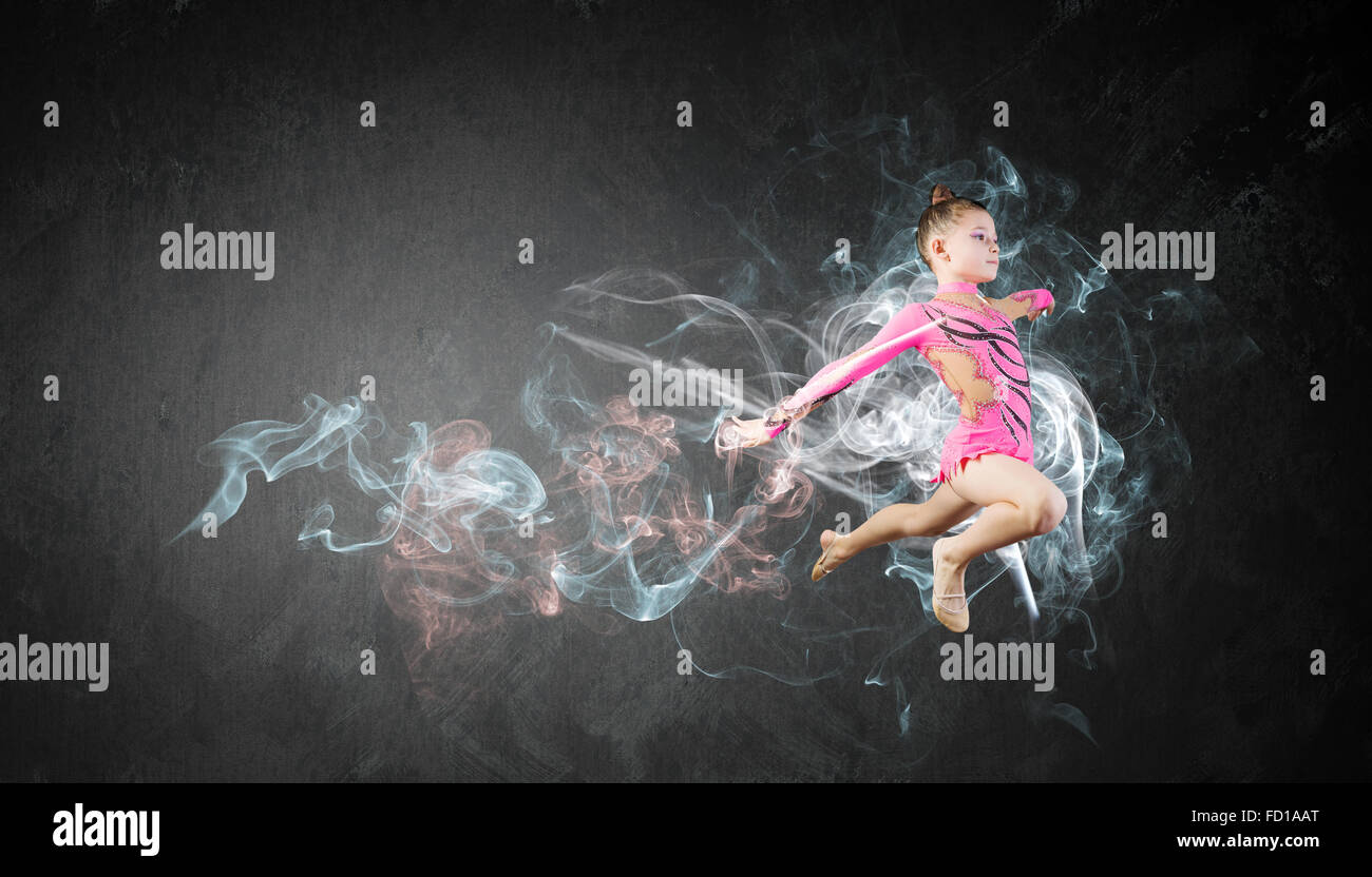 Little cute girl gymnast making high jump Stock Photo - Alamy