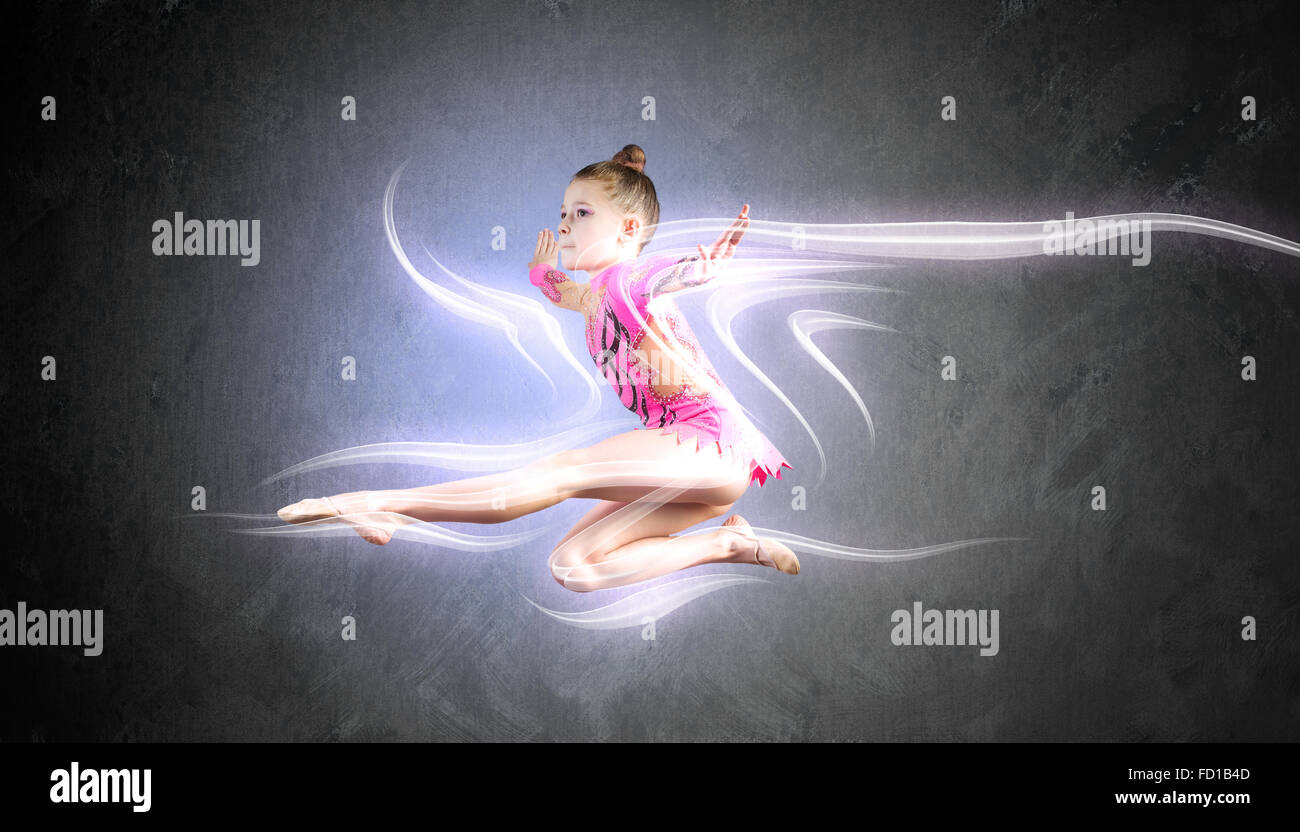 Little cute girl gymnast making high jump Stock Photo - Alamy