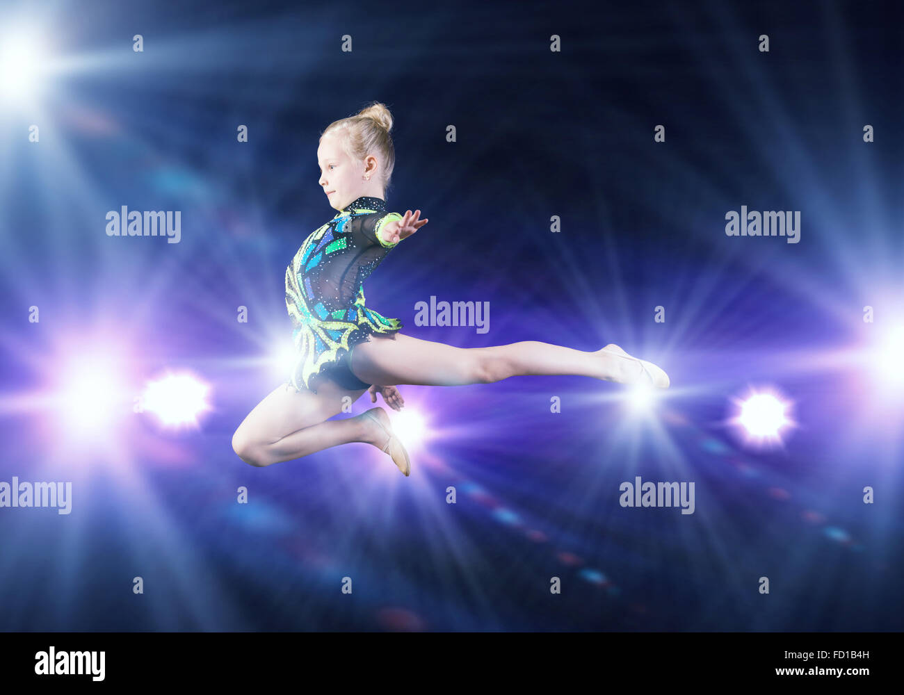 Little cute girl gymnast making high jump Stock Photo - Alamy