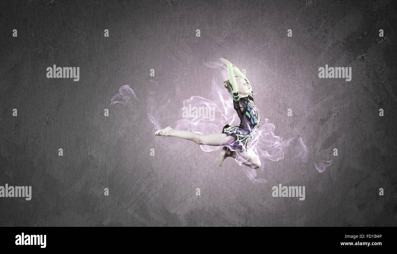 Little cute girl gymnast making high jump Stock Photo - Alamy