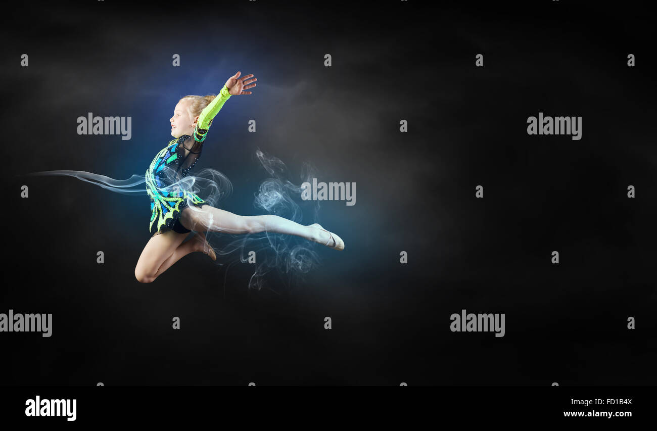Little cute girl gymnast making high jump Stock Photo - Alamy