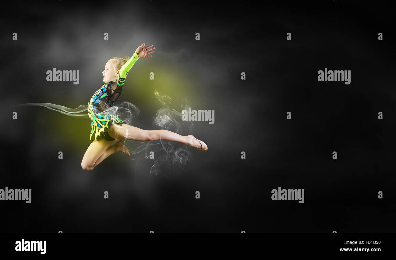 Little cute girl gymnast making high jump Stock Photo - Alamy