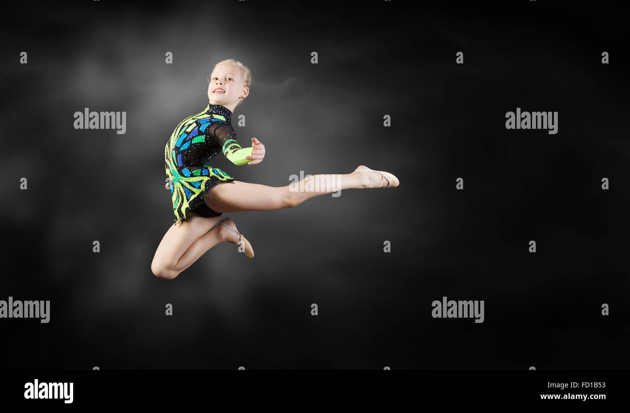 Little cute girl gymnast making high jump Stock Photo - Alamy