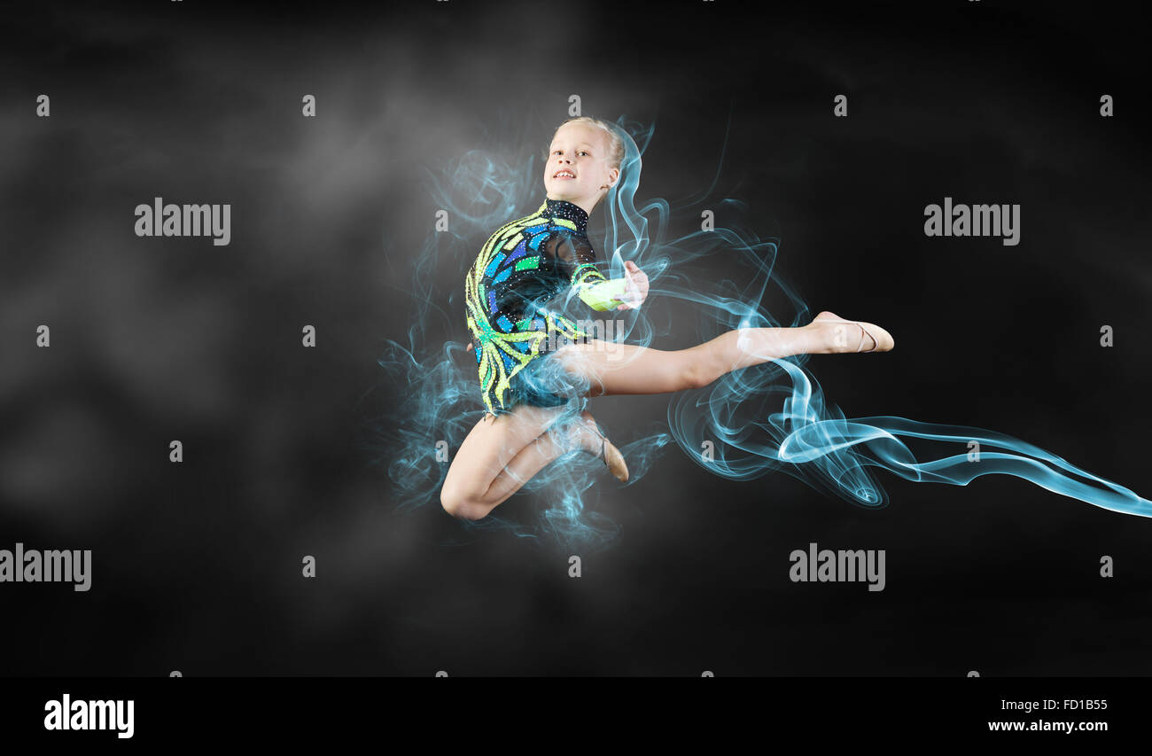 Little cute girl gymnast making high jump Stock Photo - Alamy
