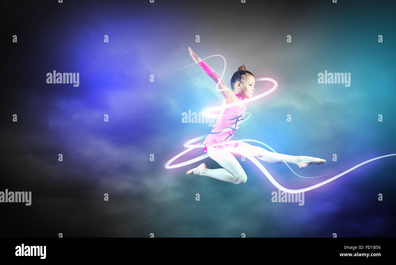 Little cute girl gymnast making high jump Stock Photo - Alamy