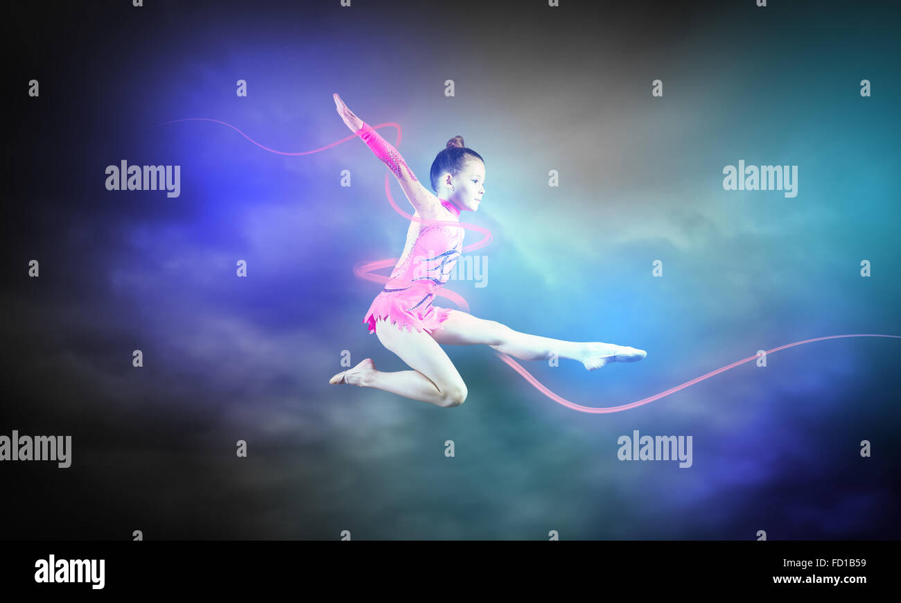 Little cute girl gymnast making high jump Stock Photo - Alamy