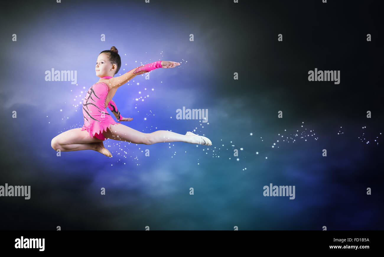 Little cute girl gymnast making high jump Stock Photo - Alamy