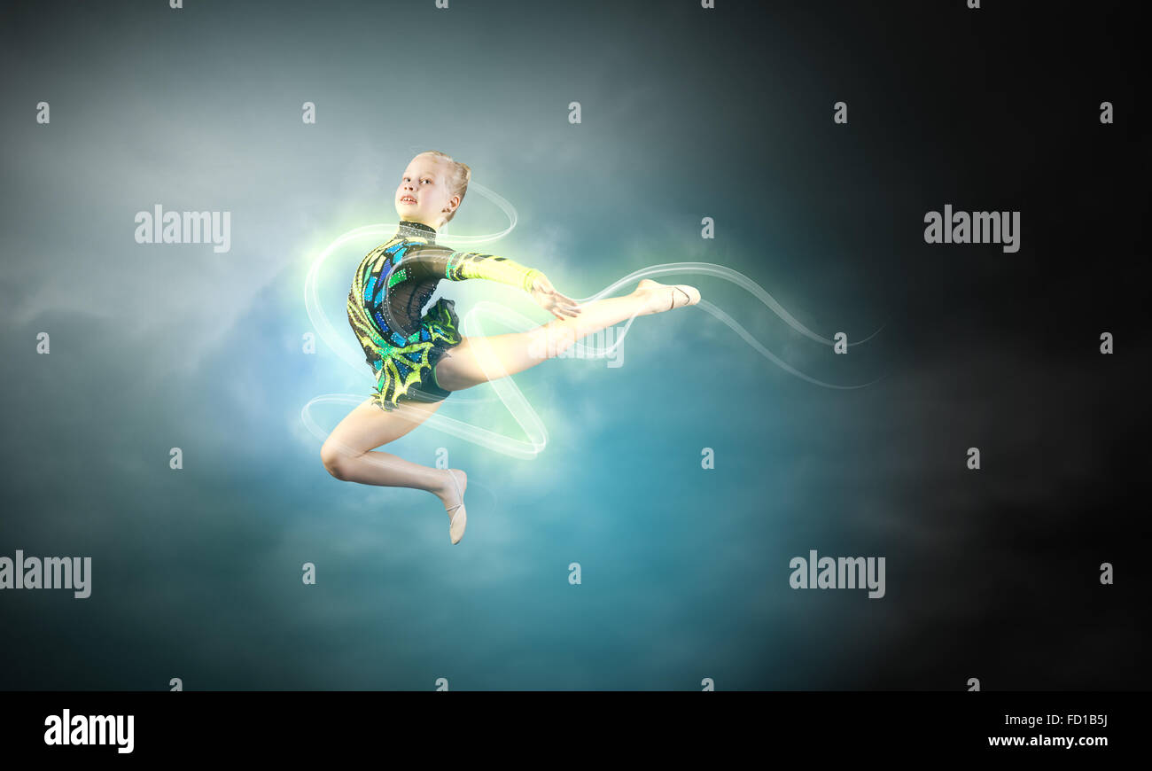 Little cute girl gymnast making high jump Stock Photo - Alamy