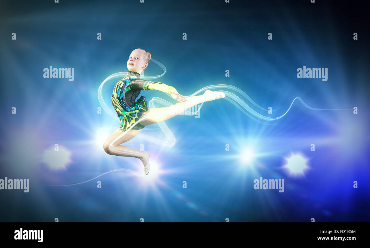 Little cute girl gymnast making high jump Stock Photo - Alamy
