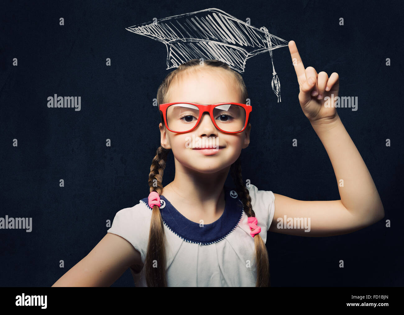 Genius girl in red glasses near blackboard in master hat Stock Photo ...