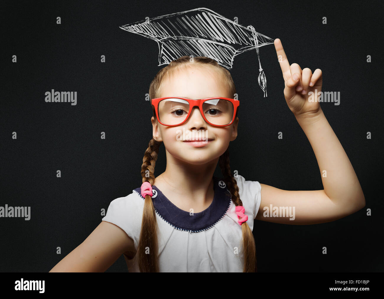 Genius girl in red glasses near blackboard in master hat Stock Photo ...
