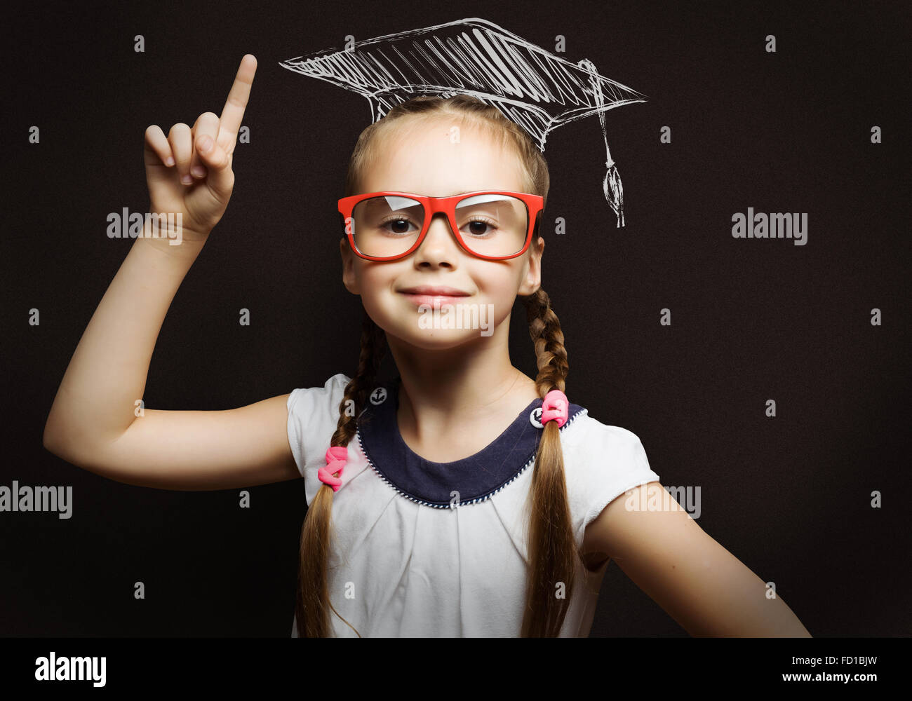 Genius girl in red glasses near blackboard in master hat Stock Photo ...