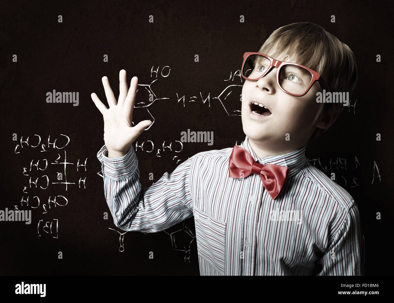 Smart boy in red glasses near blackboard with formulas Stock Photo - Alamy